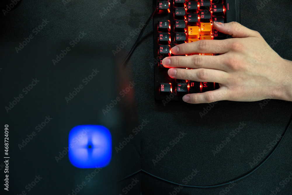 Focus on Hands, Keyboards and Mouse. Back view of young gamer playing ...