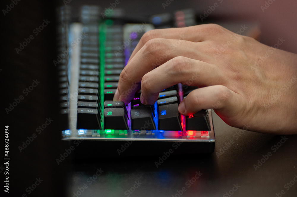 Focus on Hands, Keyboards and Mouse. Back view of young gamer playing ...