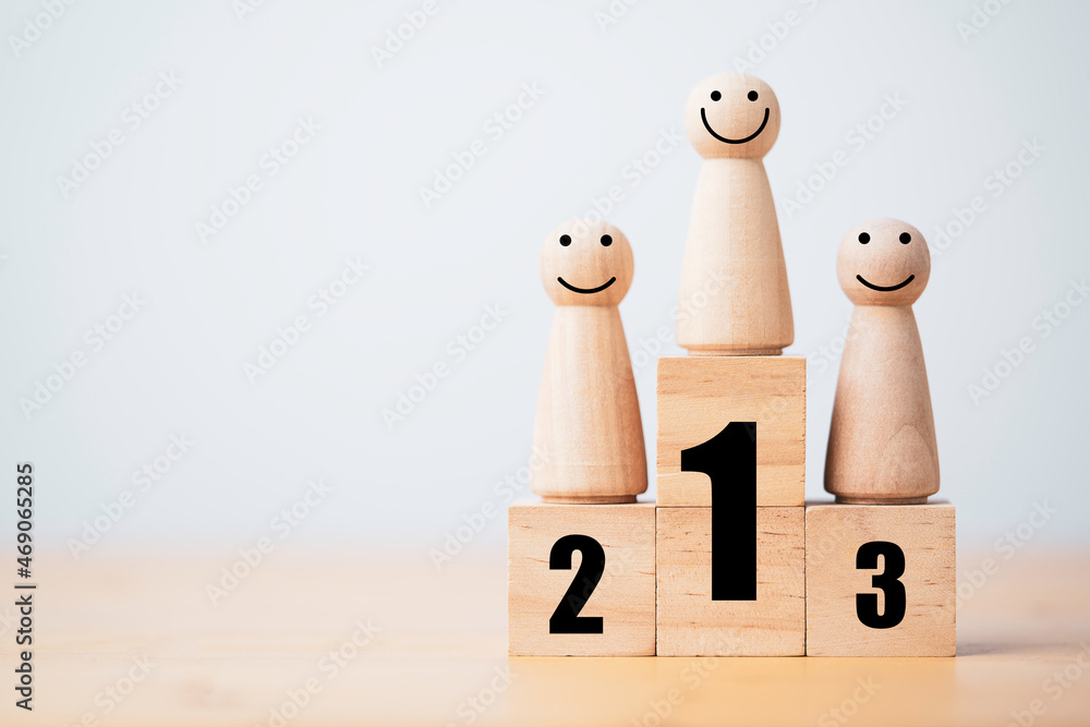Wooden human standing on podium with ranking for winner business and ...