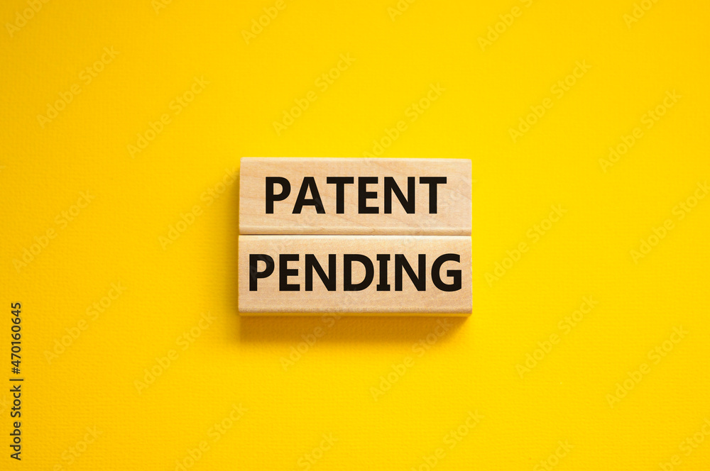 Time to patent pending symbol. Concept words Patent pending on wooden ...