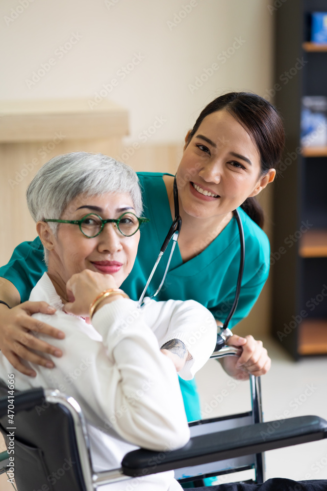 caregiver and elderly home care. Asian woman doctor or nurse talking ...