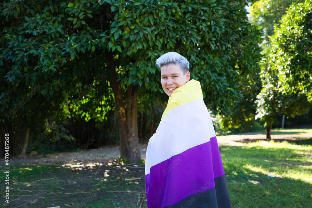 gender non-binary person has the flag of non-binary pride on his ...