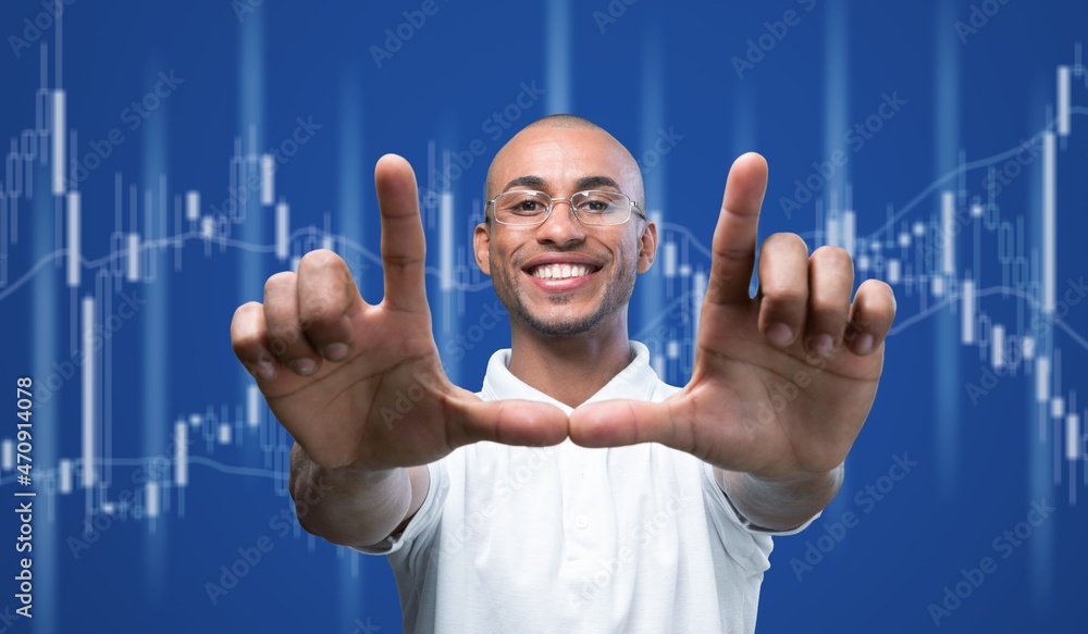 Young caucasian man, guy over dark blue background with the trading ...