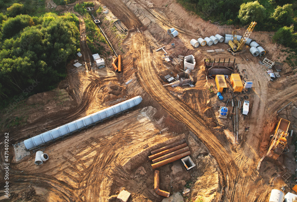 Concrete sewer pipes for laying external sewage system at construction site. Tunnel boring ...