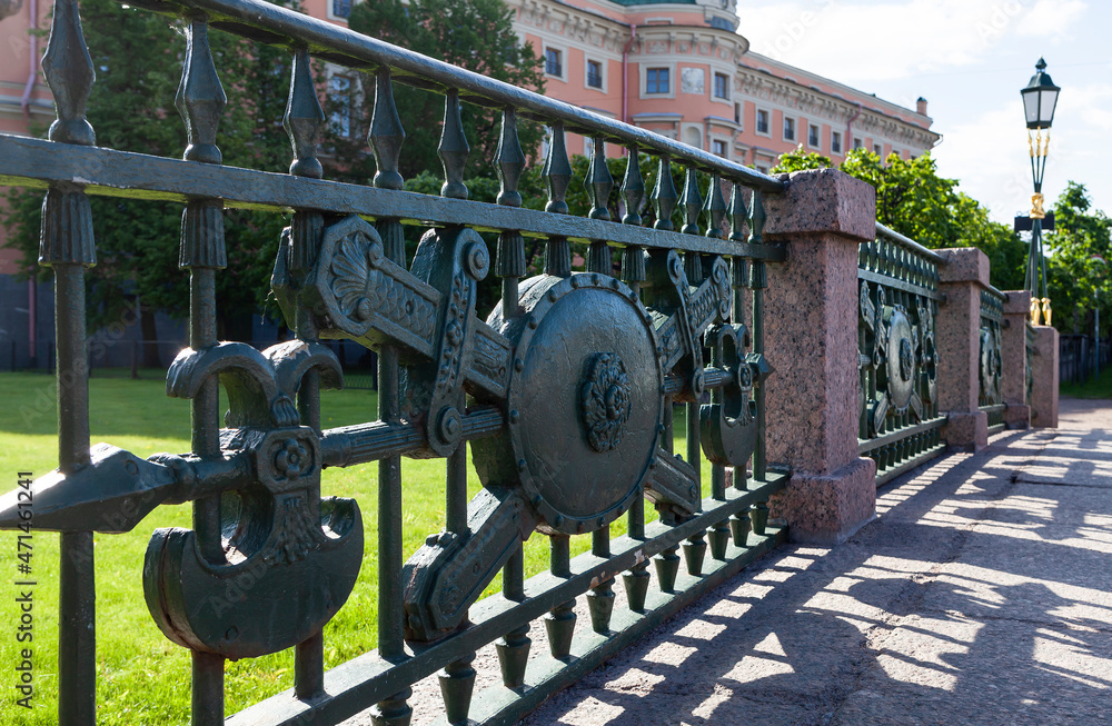 Cast-iron fence at Mikhailovsky Castle with a bas-relief in the form of ...