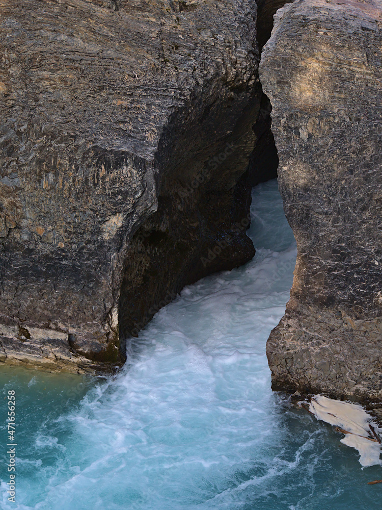 Close-up view of raging stream Kicking Horse River flowing through ...