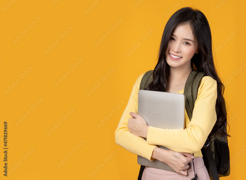 Photo Stock Happy young university student girl holding laptop computer ...