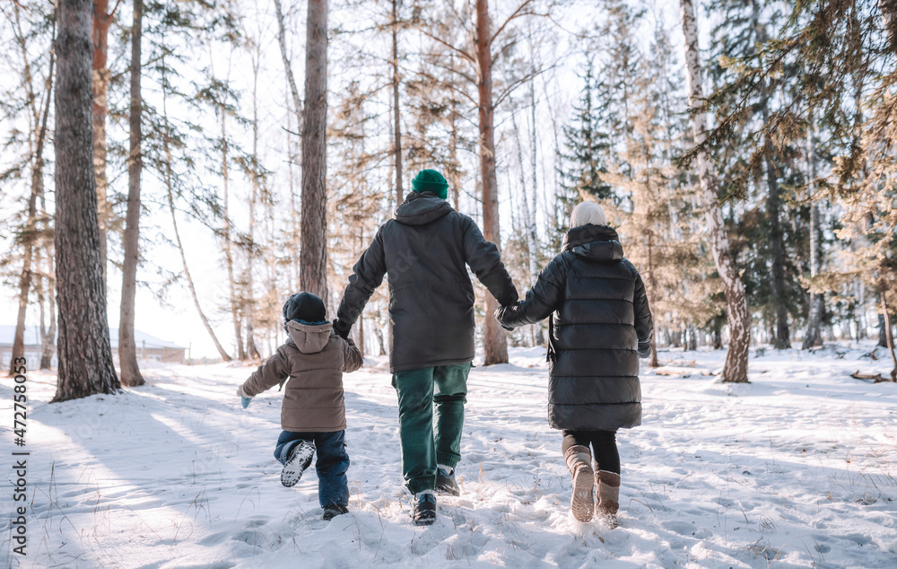 Family walking in winter forest Stock Photo | Adobe Stock