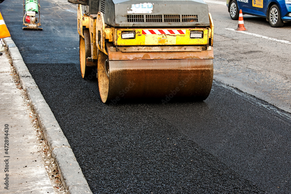Compact steamroller flatten out the asphalt. Heavy Vibration roller at ...