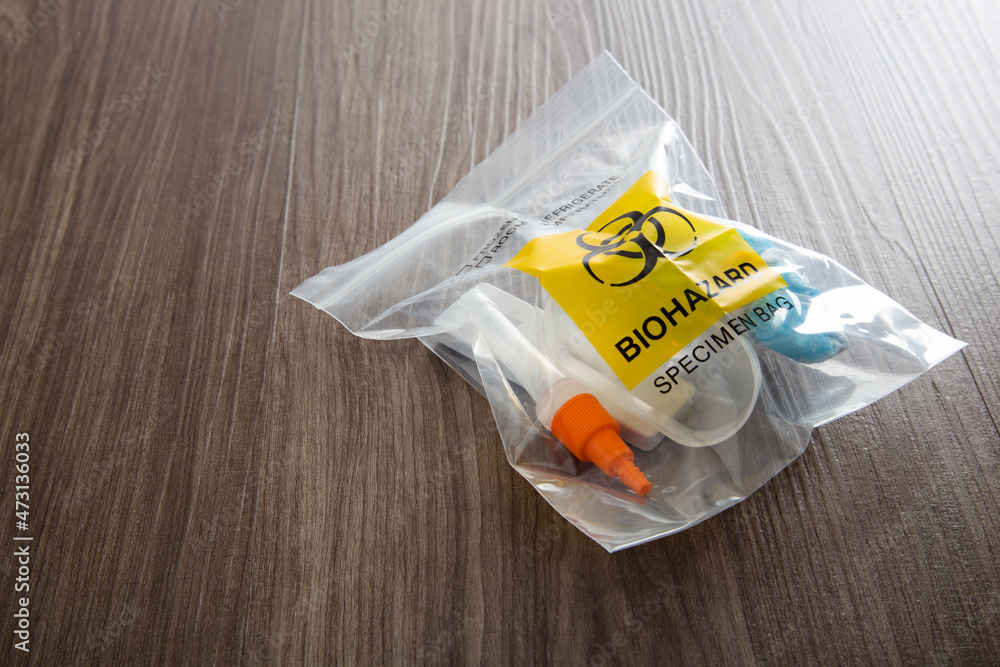 Covid-19 Rapid Antigen Test kit and biohazard specimen bag. Concept of ...