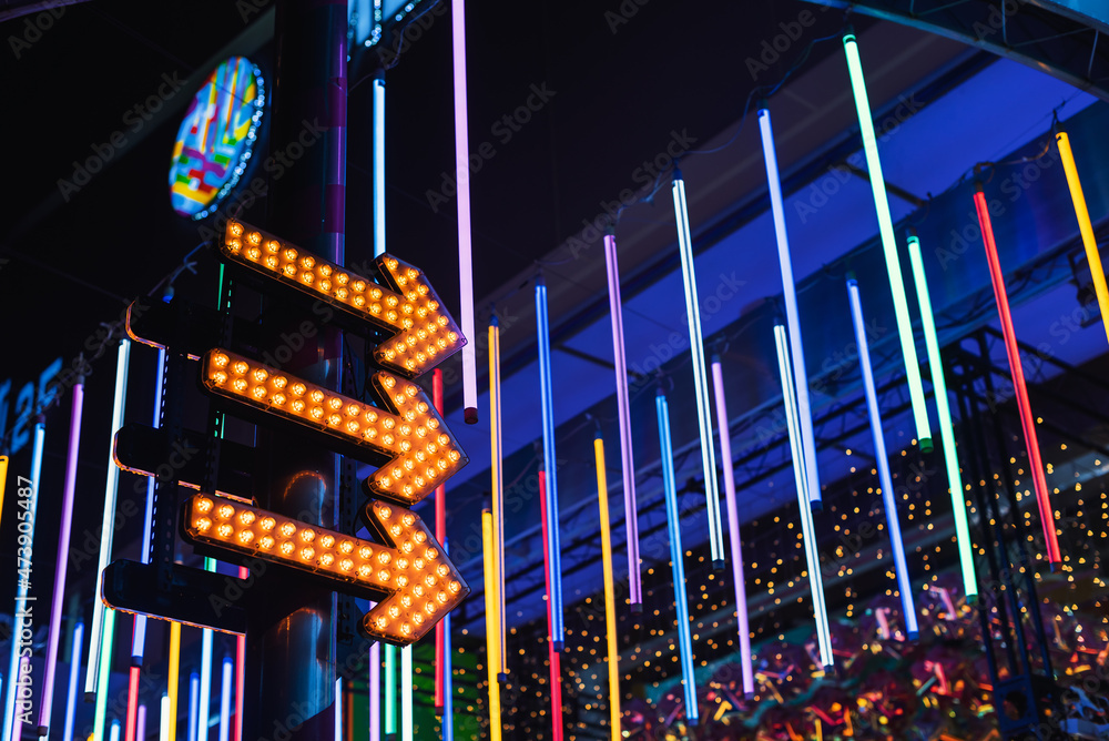 Colorful neon lights with arrow signs at night low angle view ...