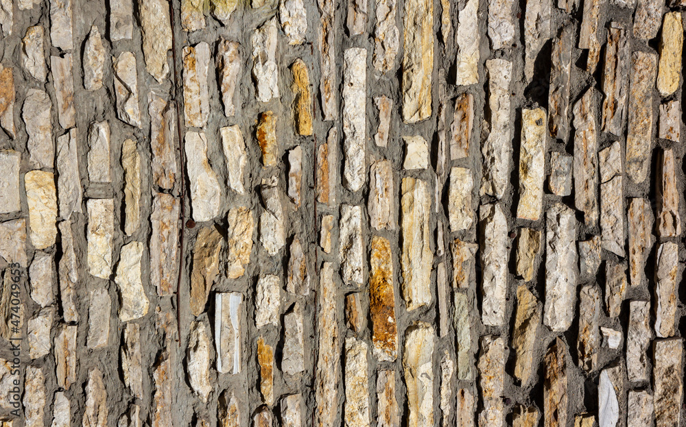 Vertically aligned limestone wall stone blocks. Colorful texture of the ...