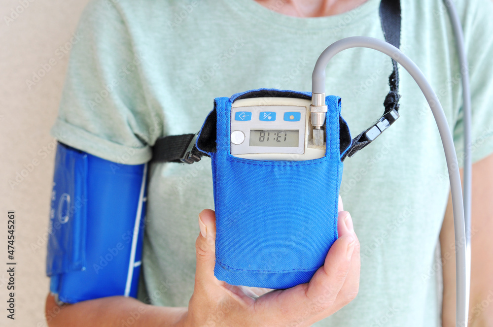 Woman wearing holter monitor device for daily monitoring of an ...