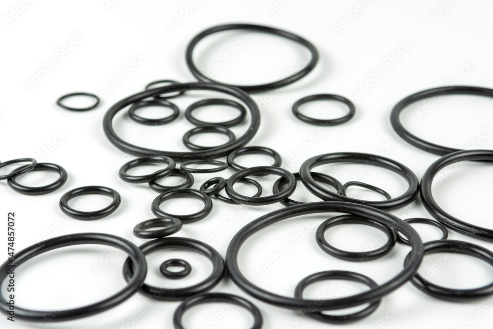 Black hydraulic and pneumatic o-rings in different sizes on a white ...