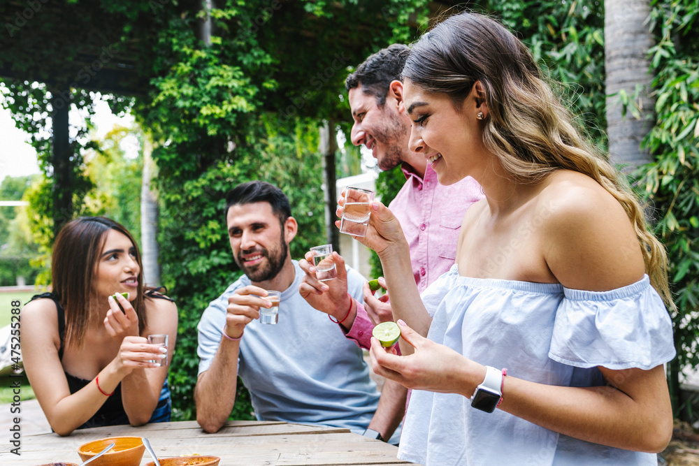 Tequila shot. Group of young latin friends meeting for tequila shot or ...