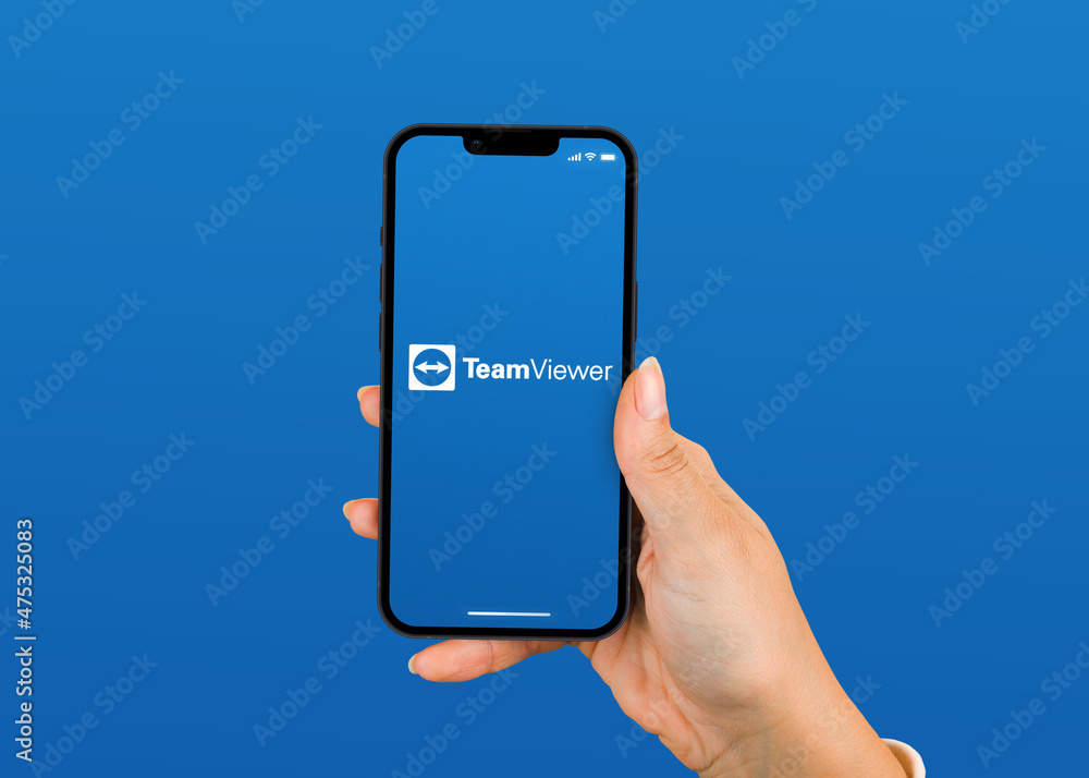Girl holding a smartphone with Team Viewer app on the screen. Blue ...