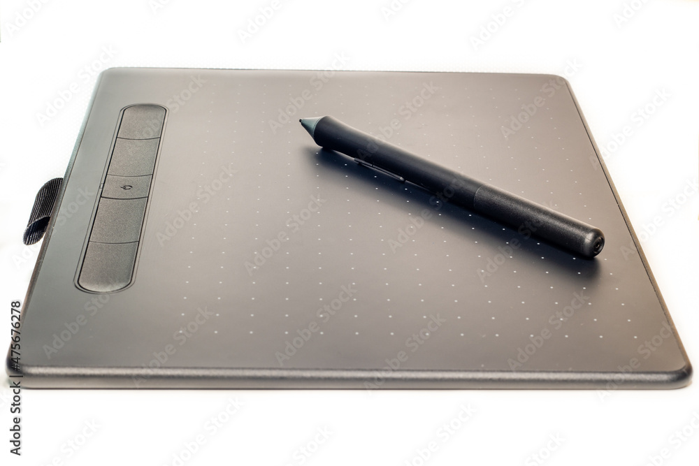 Black graphic tablet with white dots on a white background in vertical ...