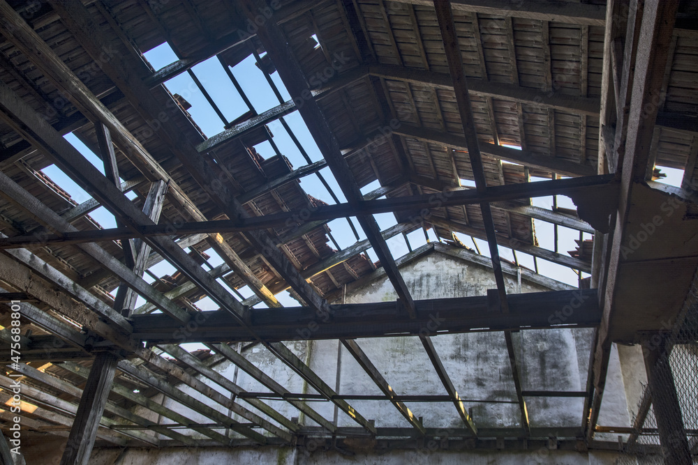 Old ruined warehouse that was almost demolished. The sky can be seen ...