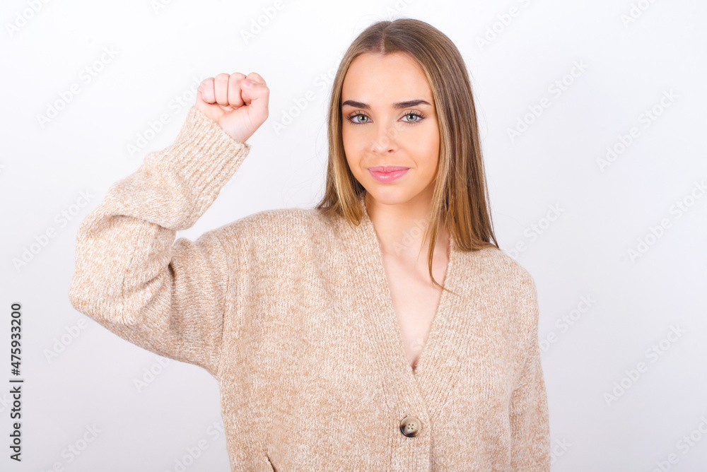 young caucasian girl wearing knitted sweater over white background ...