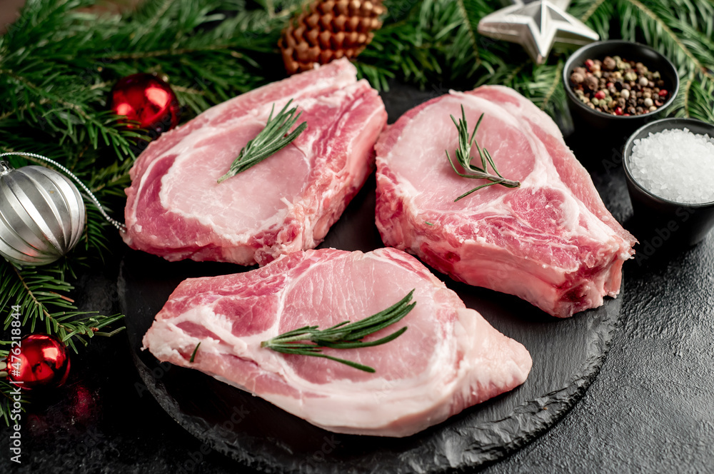 Christmas raw pork steaks, with fir tree and new year decorations on ...