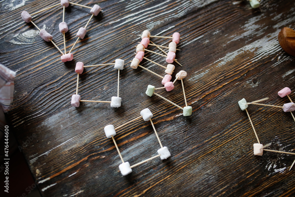 Children play with marshmallows and toothpicks, edible designer in the ...