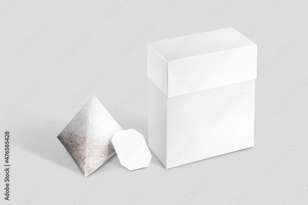 Blank tea bags with label tag and dried leaves inside. Tea box ...