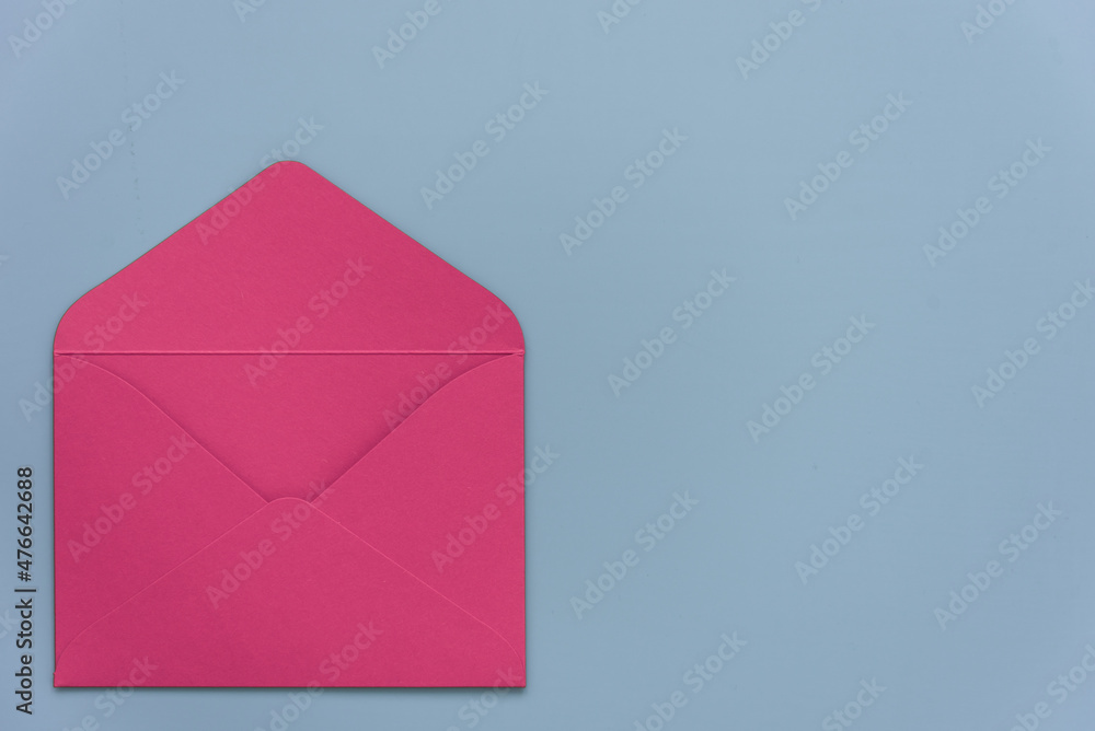 Bright pink envelope on a monochromatic background. Space for text ...