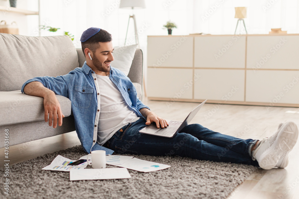Smiling jew man watching video on computer, wearing headphones Stock ...