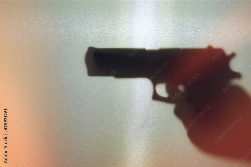 Foto de Stock Shadow of a hand with a pistol. Hand holding a gun ...