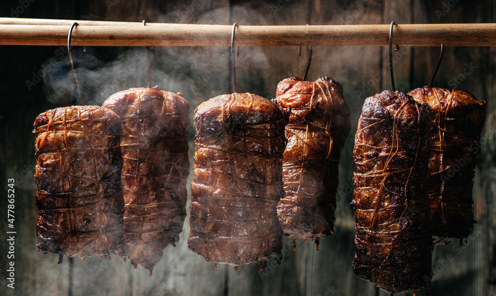 ภาพถ่าย Stock Smoked pork. Traditional method of smoking meat in smok ...