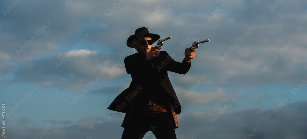 American cowboy shooting. Handsome brutal western guy. Sheriff with ...