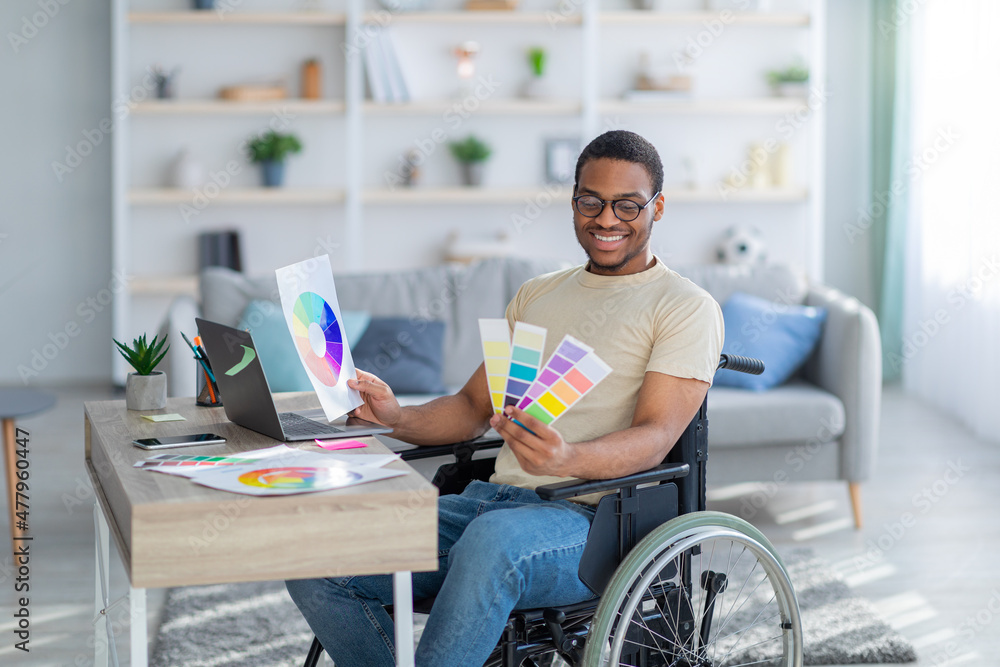 Disabled black guy in wheelchair working as graphic designer online ...