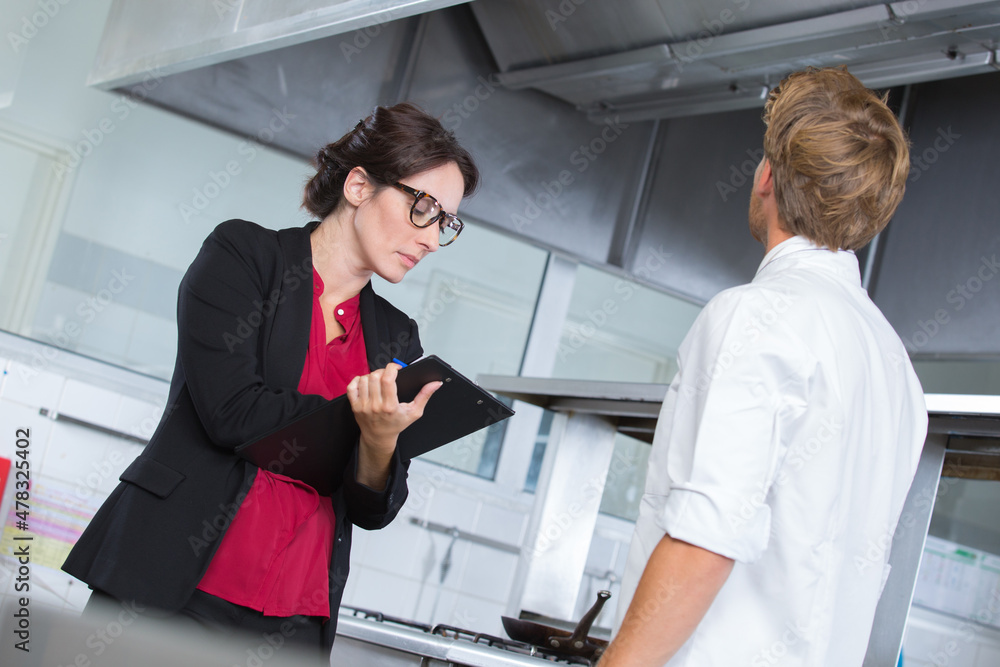 health inspector inspecting a kitchen Stock Photo | Adobe Stock