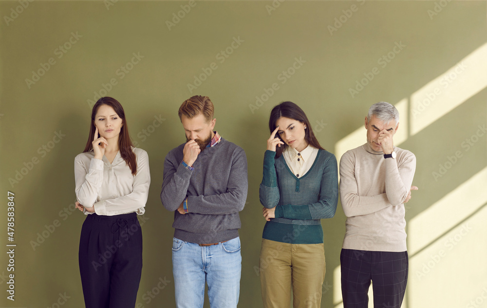 Group of serious adult people thinking hard. Studio portrait of pensive ...