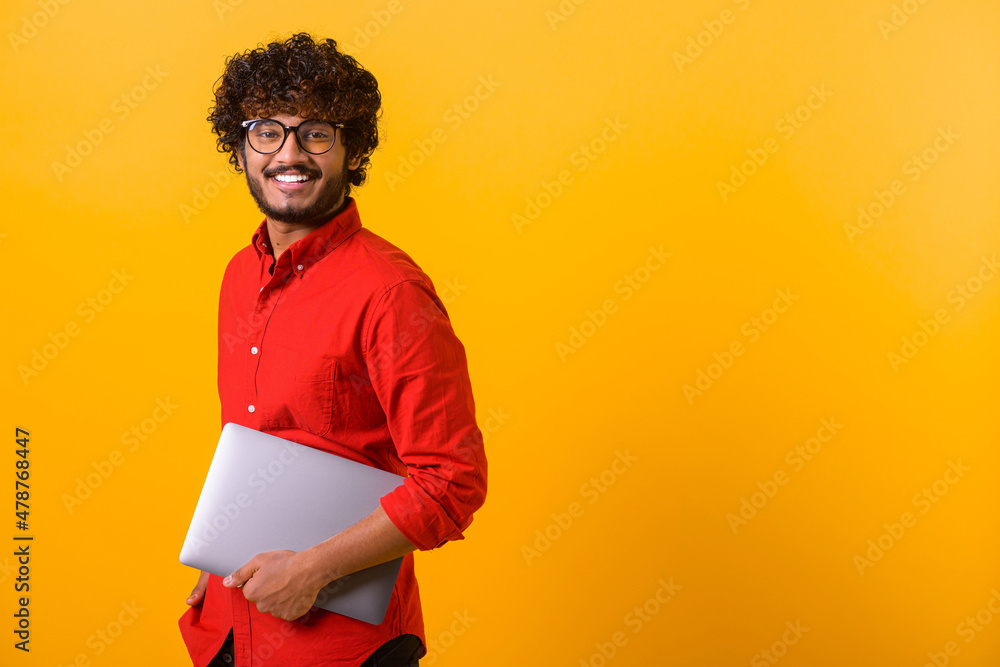 Waist up portrait view of the smiling positive indian man holding ...