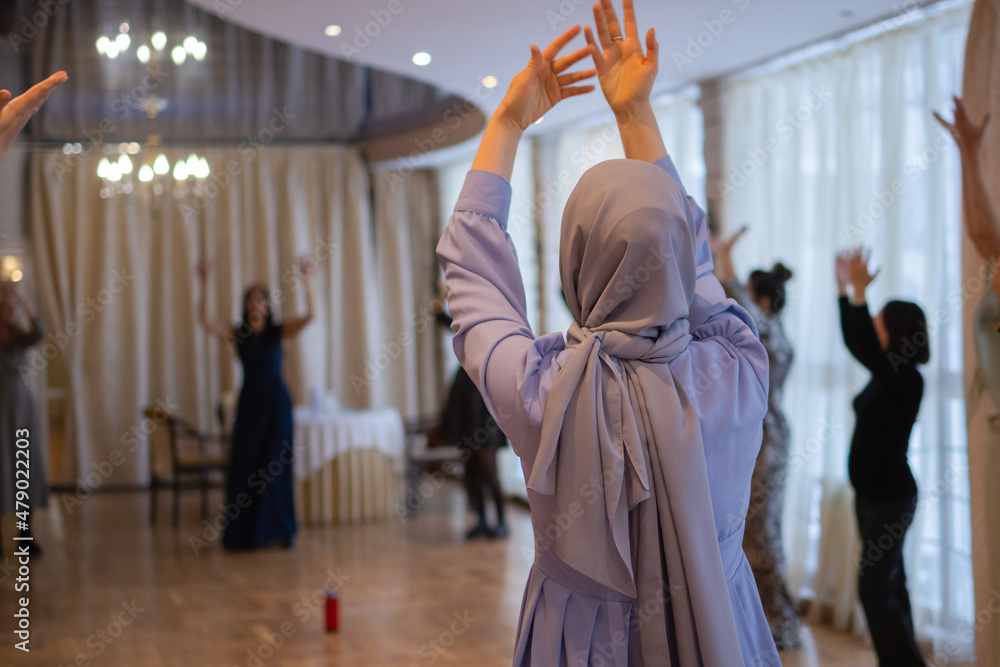 Woman putting hands up and dancing. Excited young female celebrating a ...