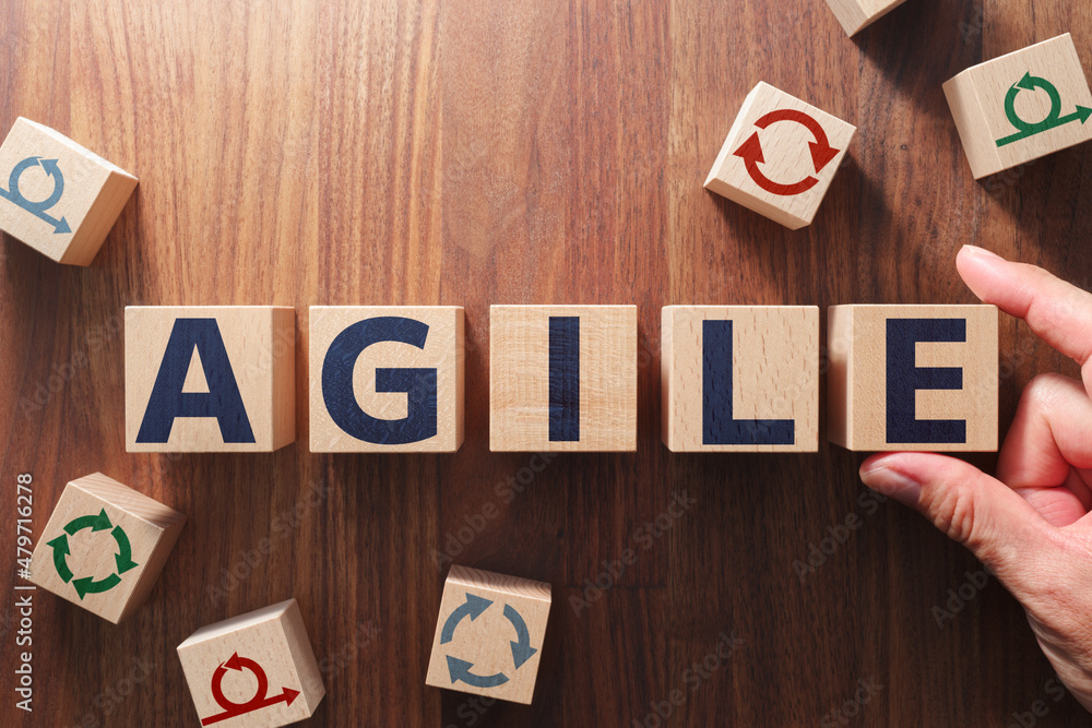 The word "AGILE". Agile project management concept. Putting wood cubes ...