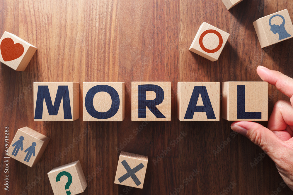 The word "MORAL". Concept image of moral issue. Putting wood cubes with ...