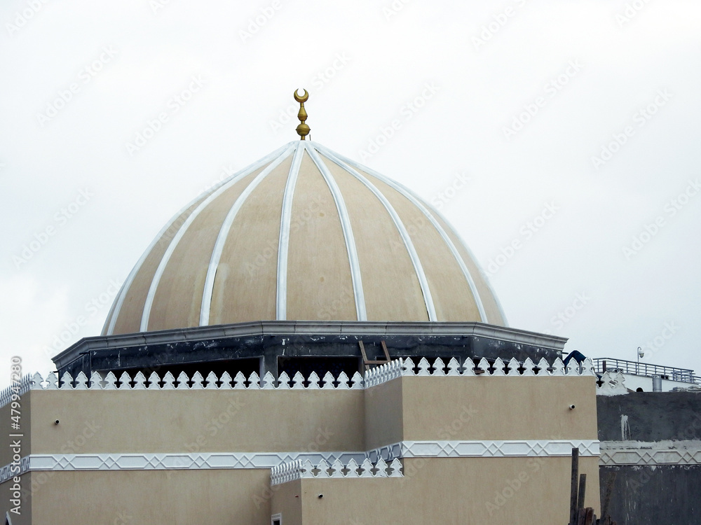 Islamic dome in beige and white colors as a part of a mosque that is ...