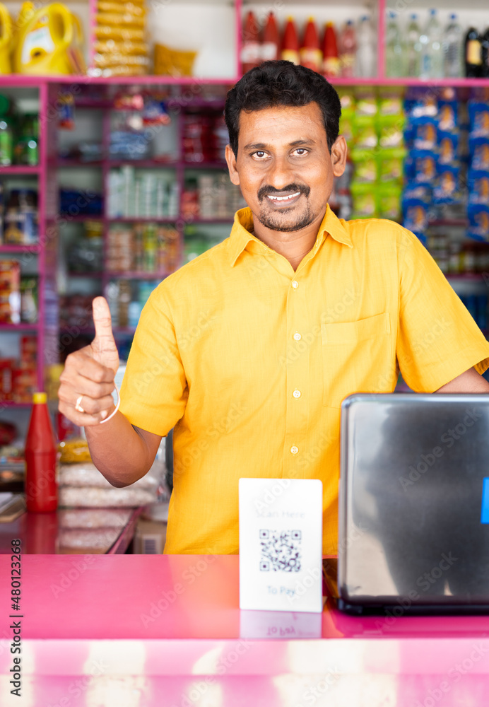 Portrait shot of Kirana or groceries store merchant showing thumbs up ...