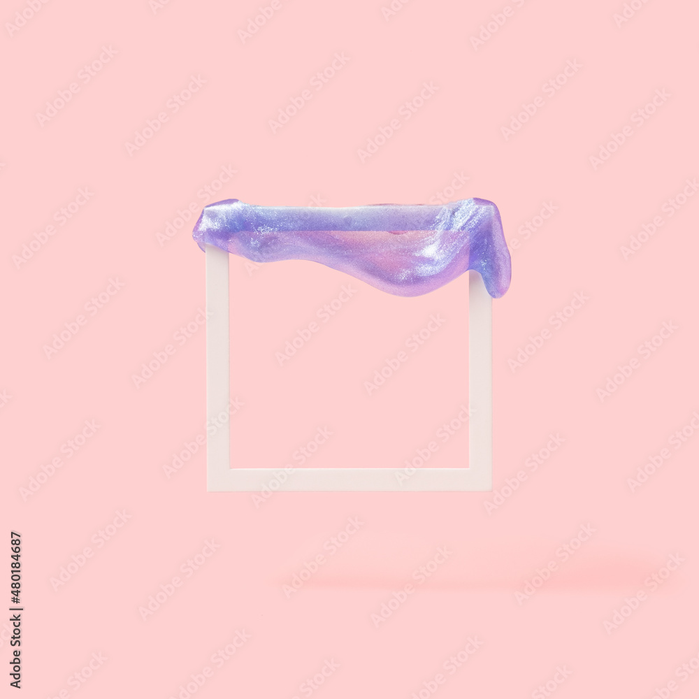 Square frame with violet slime on top on a pastel pink background ...