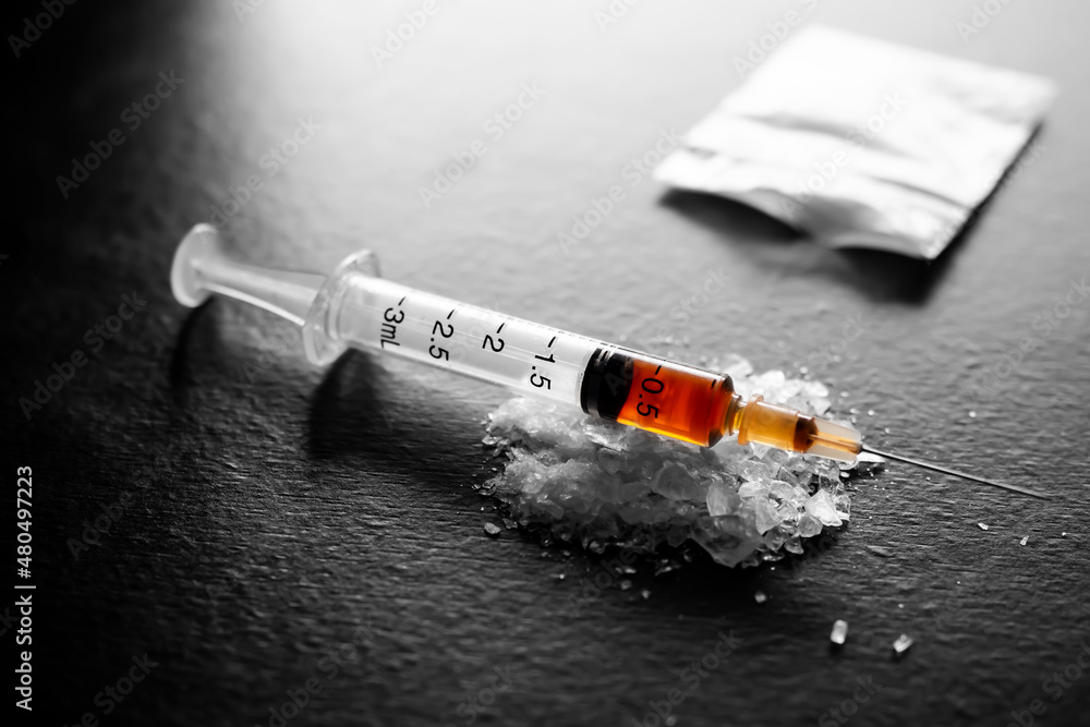 Heroin in syringe with blur powder heroin in plastick zip pack ...