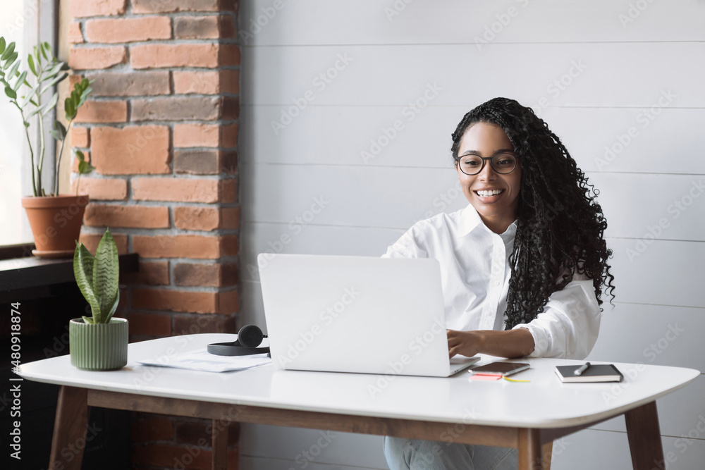 Young woman using laptop computer at office. Student girl working at ...