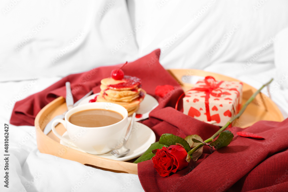 Tray with breakfast, rose and gift for Valentine's Day on bed Stock ...