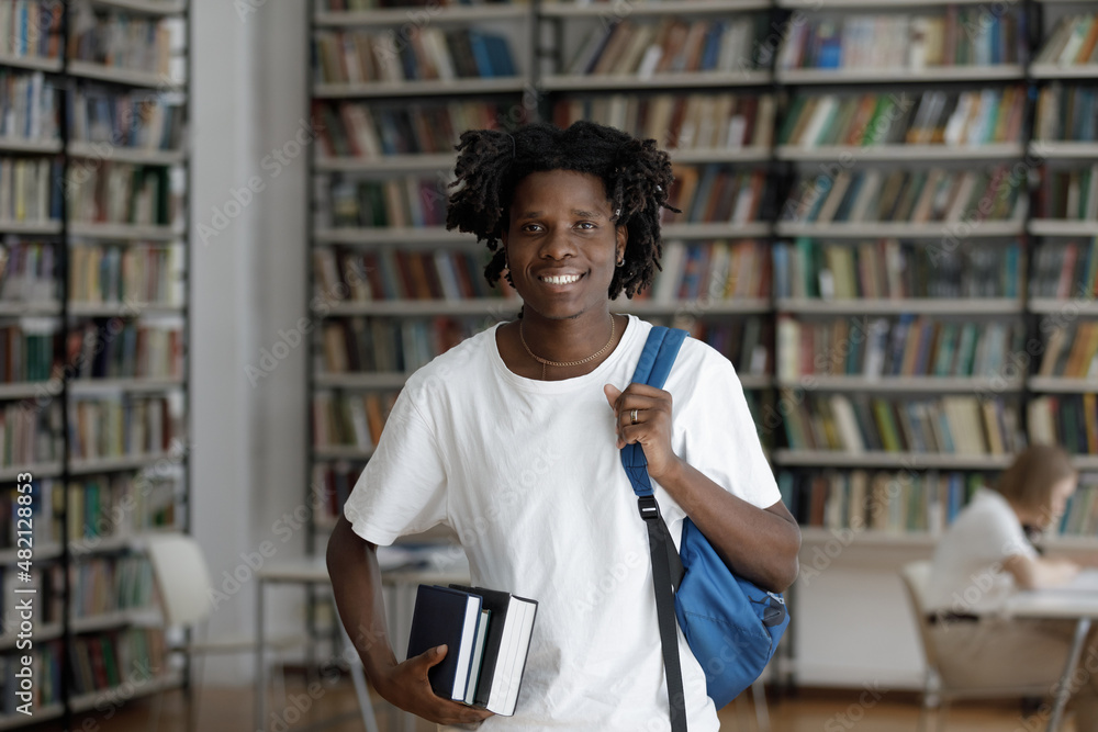 Happy African American student guy with dreads and backpack standing in ...