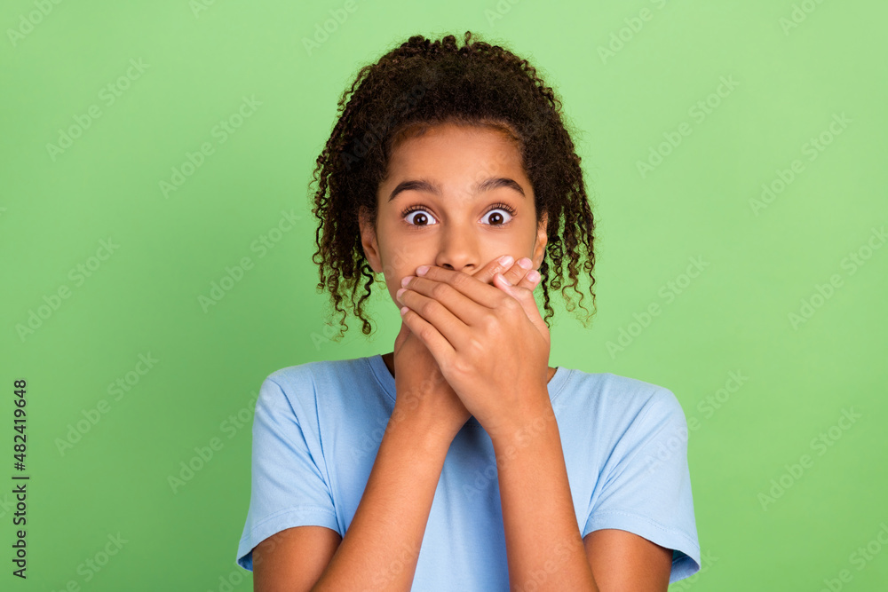 Photo of young black preteen girl cover mouth hands scared mute oops ...