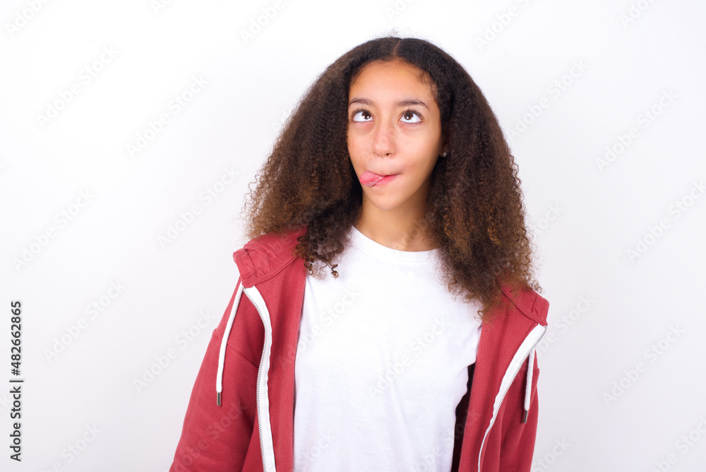 teenager girl wearing pink jacket standing against wite background ...