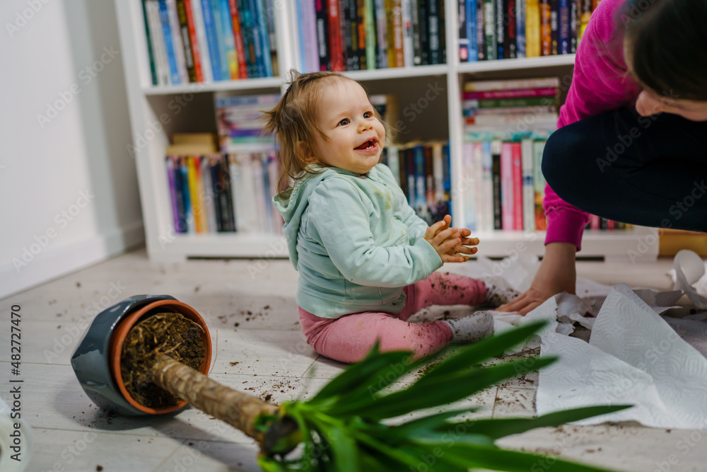 one caucasian baby girl making mess playing and mischief with bad ...