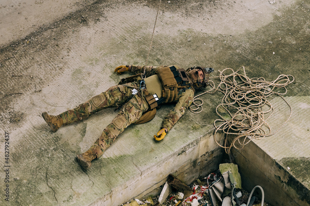 Special forces soldier pretending dead, showcasing fall from the rope ...