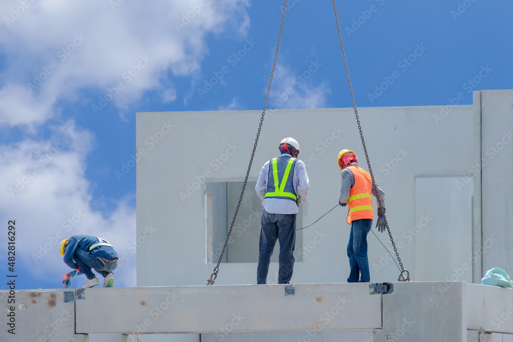 Construction worker are installing the precast concrete beam at housing ...